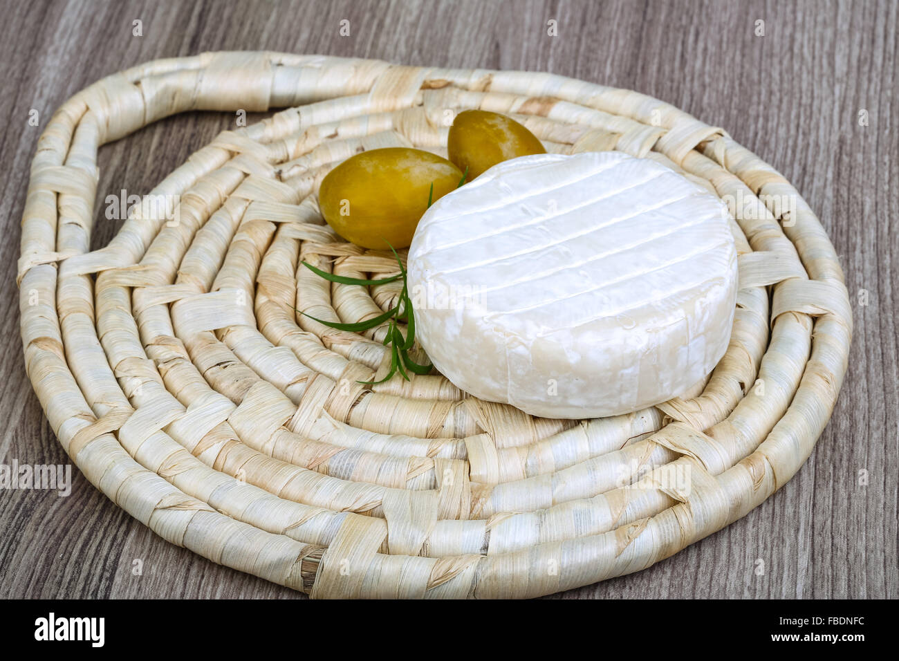 Round Brie cheese with yellow plums and estragon Stock Photo - Alamy