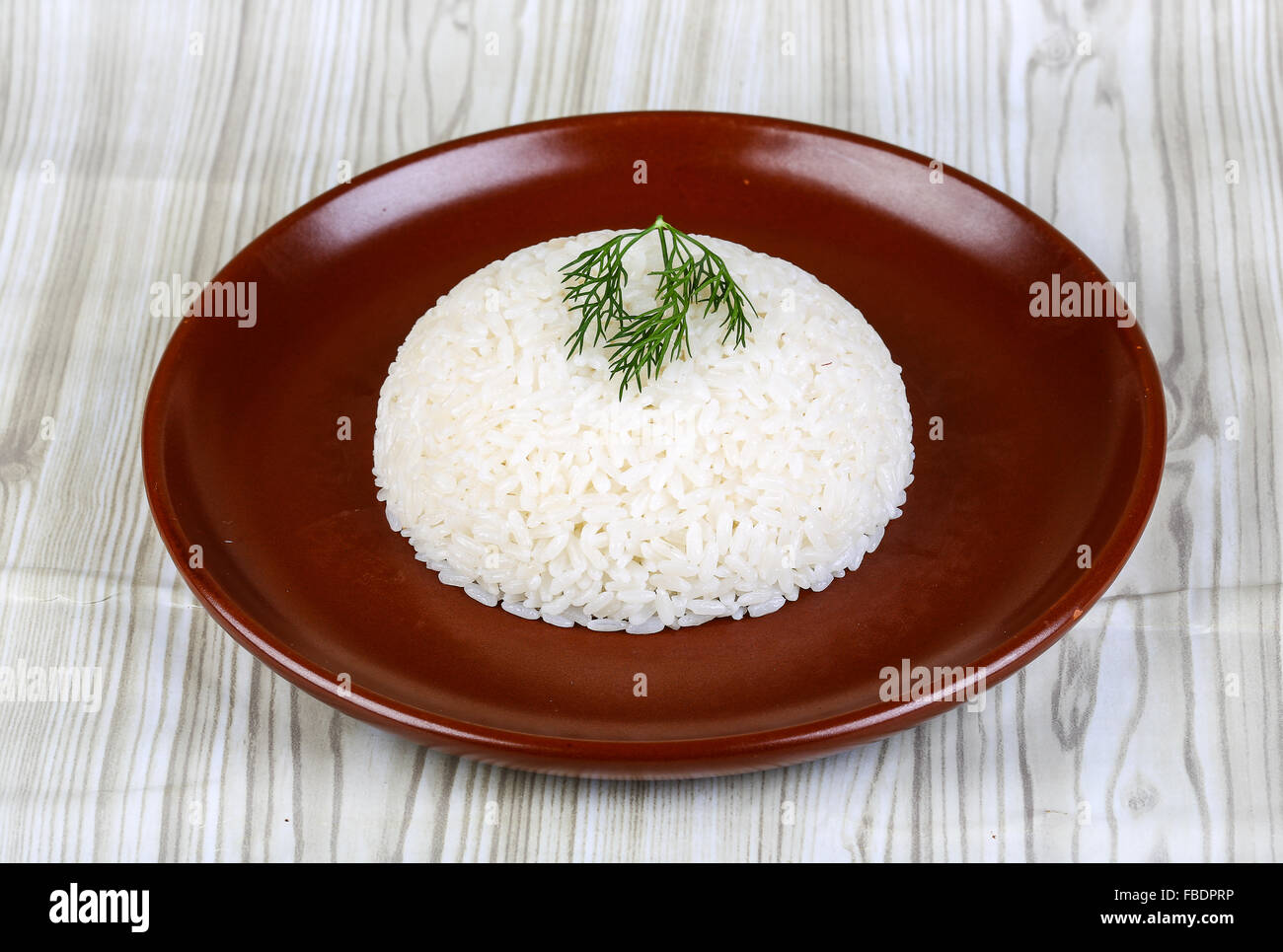 Hot Steamed rice with dill branch on the brown plate Stock Photo - Alamy