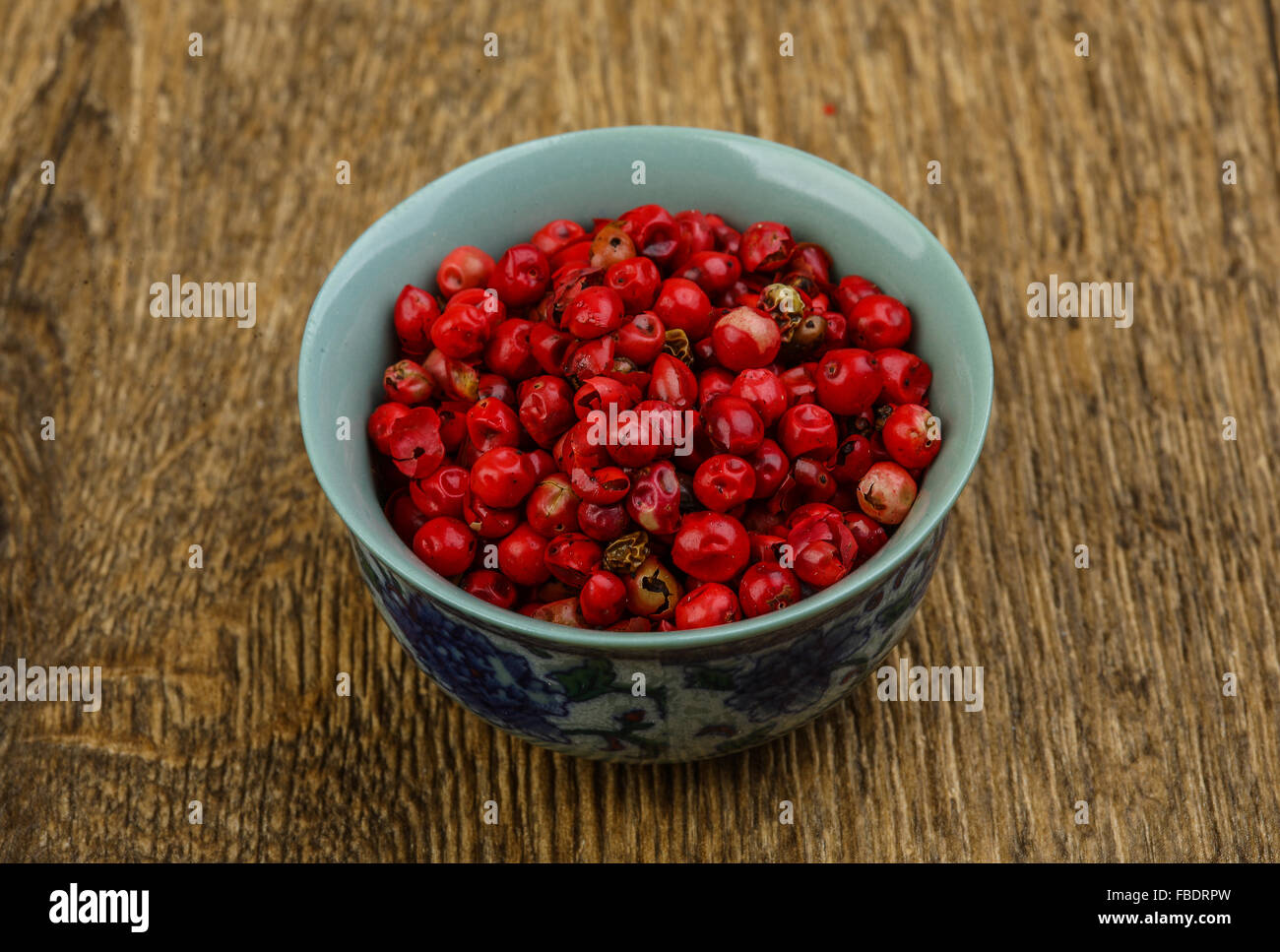 Dry Rose pepper corn on the wood background Stock Photo - Alamy