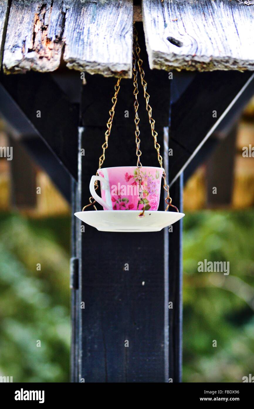 Tea Cup Hanging On Pole In Garden Stock Photo - Alamy