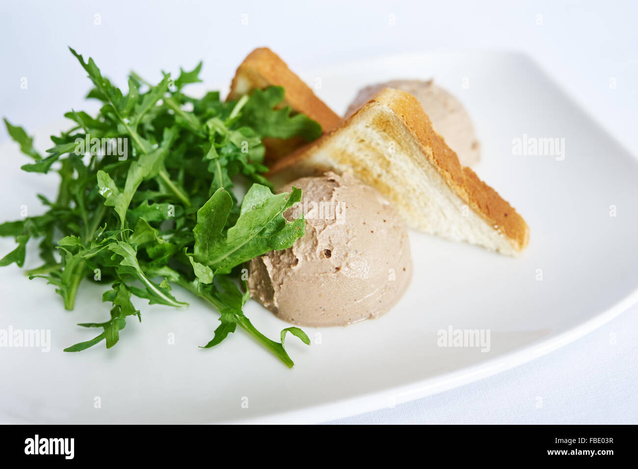 Chicken liver pate on white plate studio shot Stock Photo - Alamy