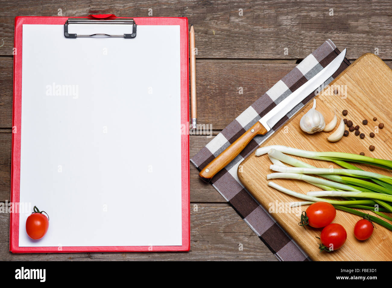 Open blank recipe book on brown wooden background with tomatoes, garlic ...