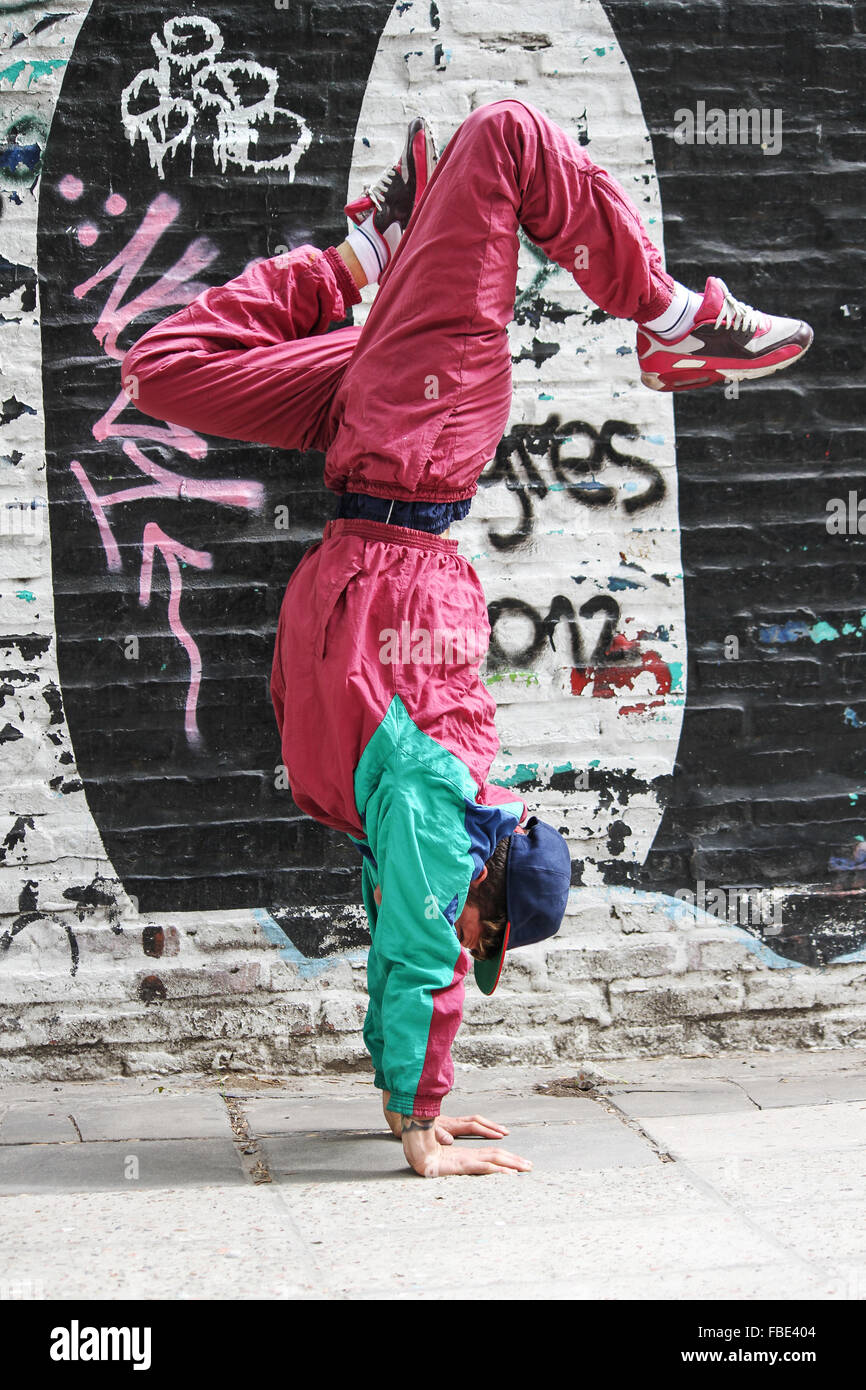 A colorful performing hip-hop dancer in front of a graffiti wall Stock ...