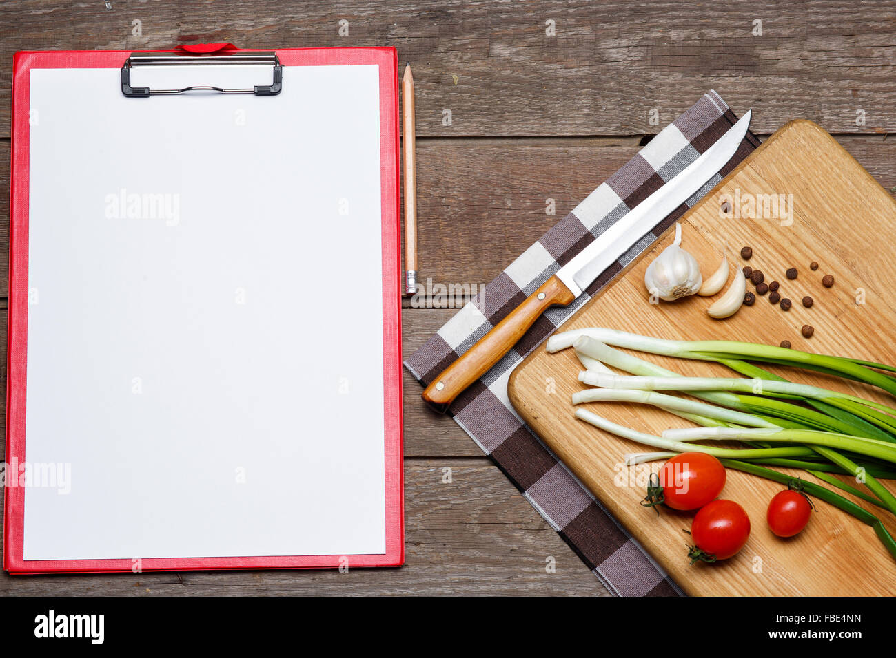 Open blank recipe book on brown wooden background with tomatoes, garlic ...