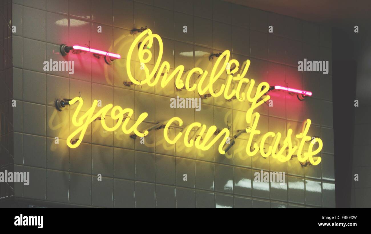 Illuminated Text On Tile Wall Stock Photo - Alamy