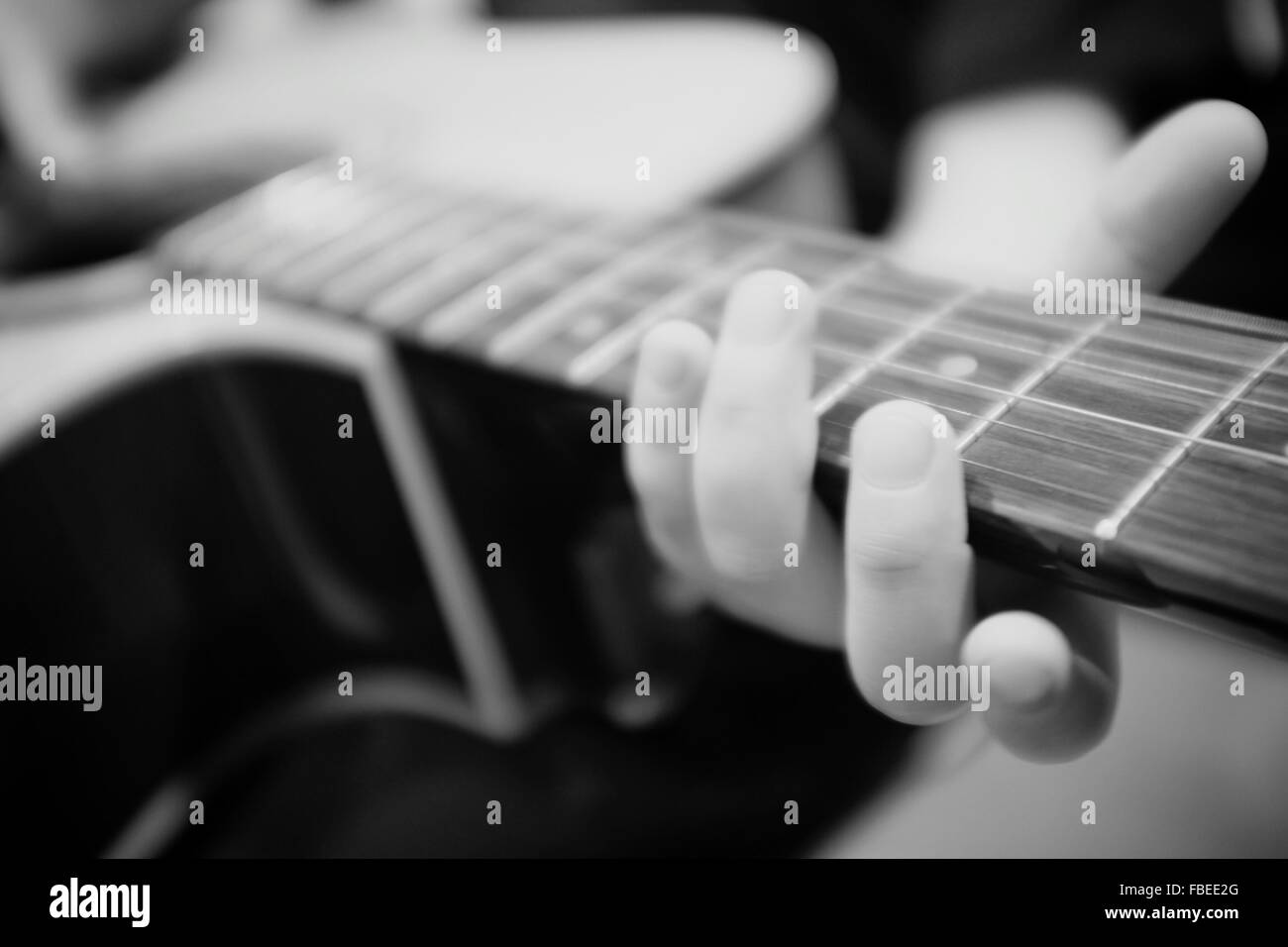 Close-Up Of Hand Holding Guitar Stock Photo - Alamy