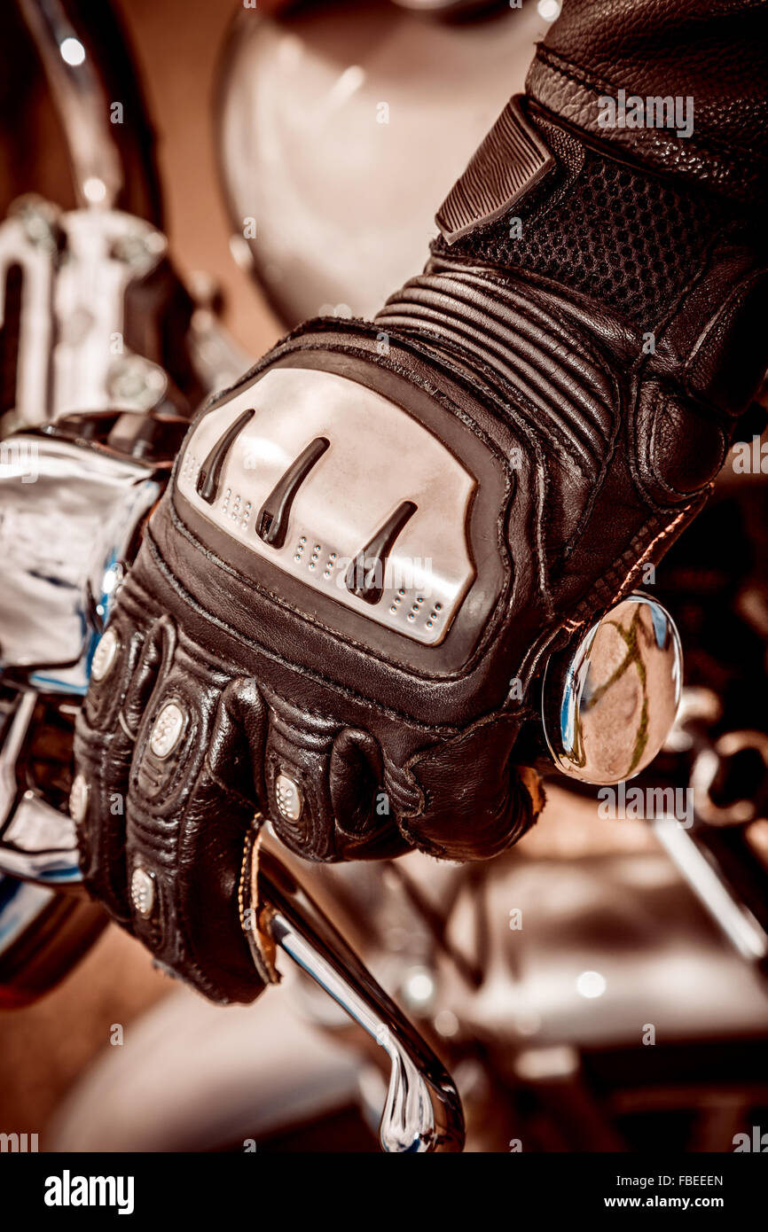 Human hand in a Motorcycle Racing Gloves holds a motorcycle throttle ...