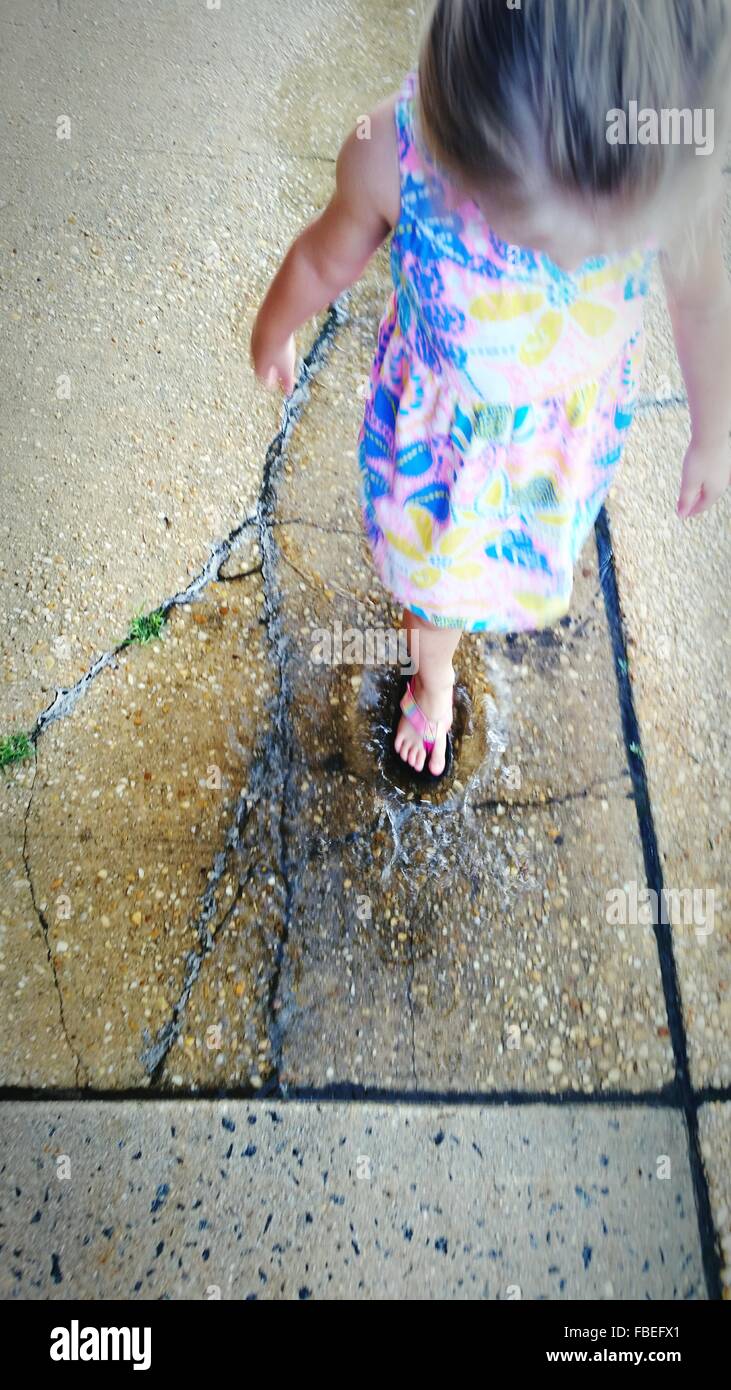 Girl Splashing In Puddle Stock Photo - Alamy