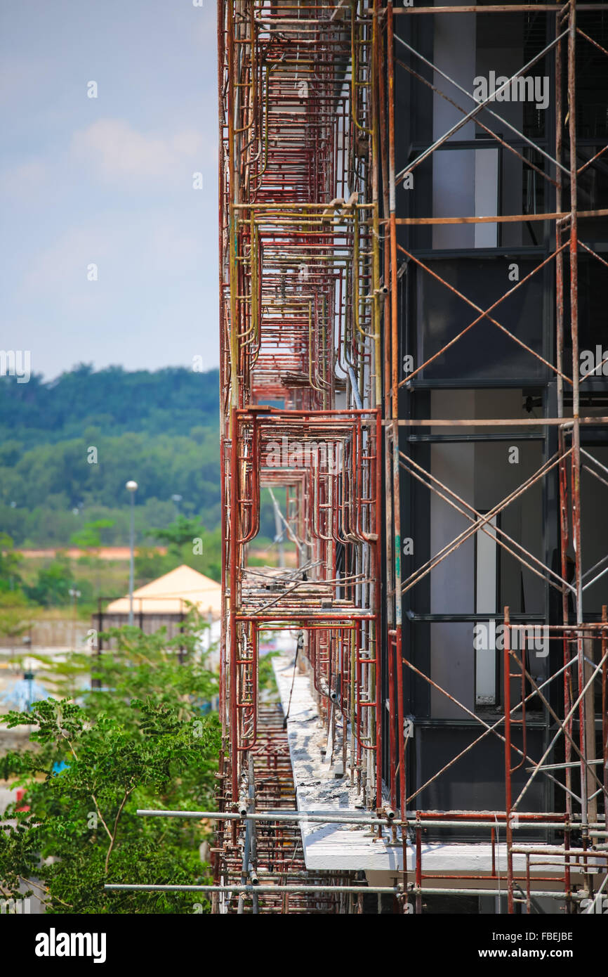 Commercial building construction work in progress with scaffolding ...