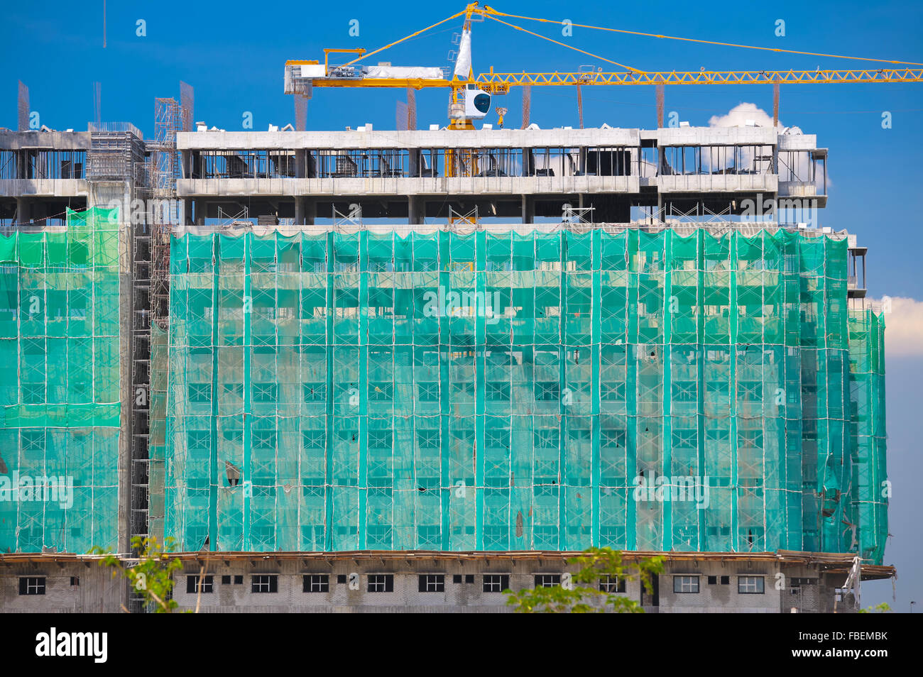 Highrise commercial building construction work in progress with safety ...