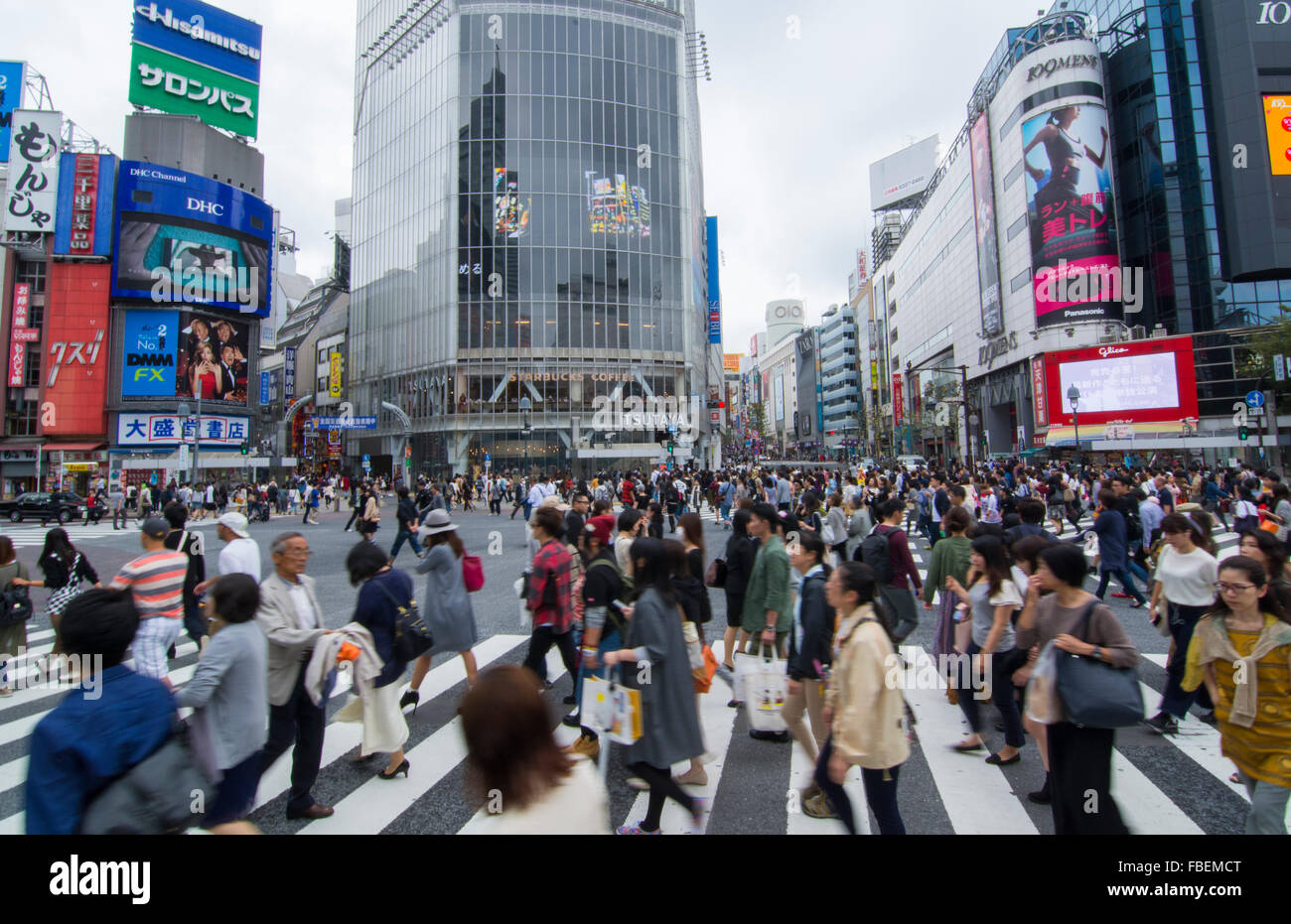 Tokyo Japan crowds rush moving walking in the busy Shibuya Station area ...