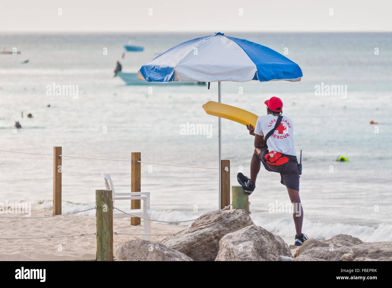 A red cross lifeguard is patrolling the tropical beach Stock Photo - Alamy