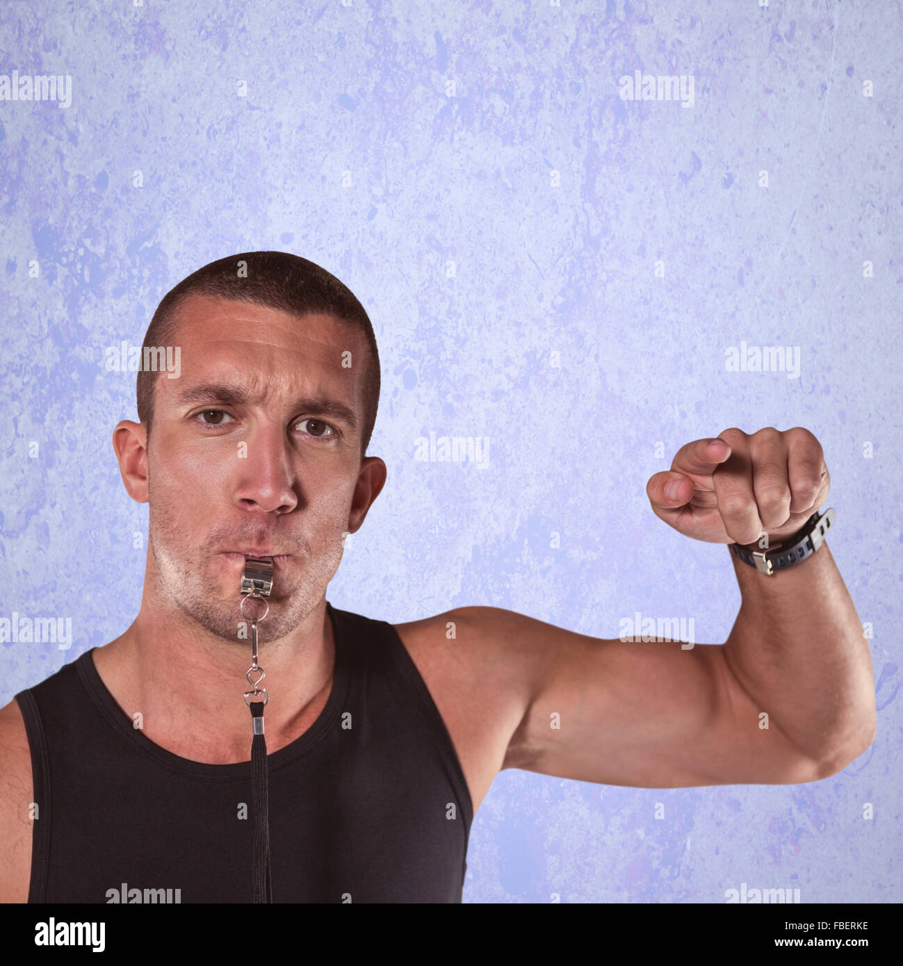Composite image of portrait of attentive trainer blowing his whistle ...