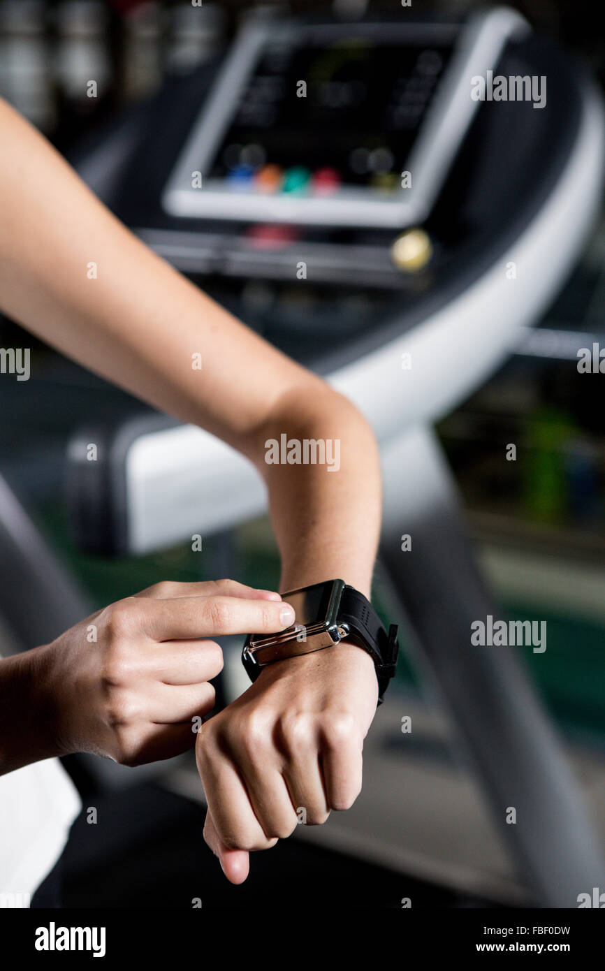 Woman scrolling smart watch Stock Photo - Alamy