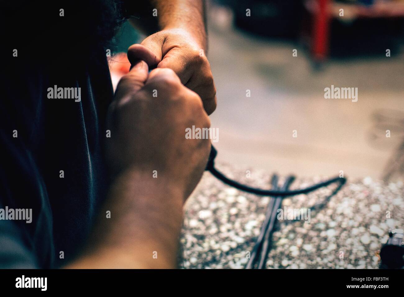 Cropped Hand Of Man Mending Wire Stock Photo - Alamy