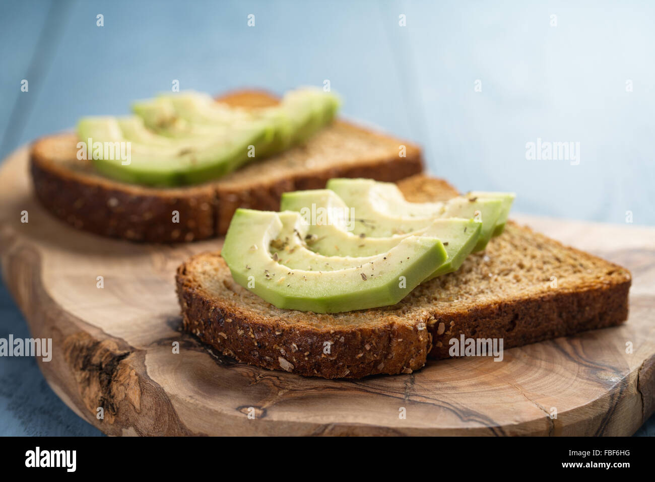 toasted rye bread with sliced avocado and herbs Stock Photo - Alamy