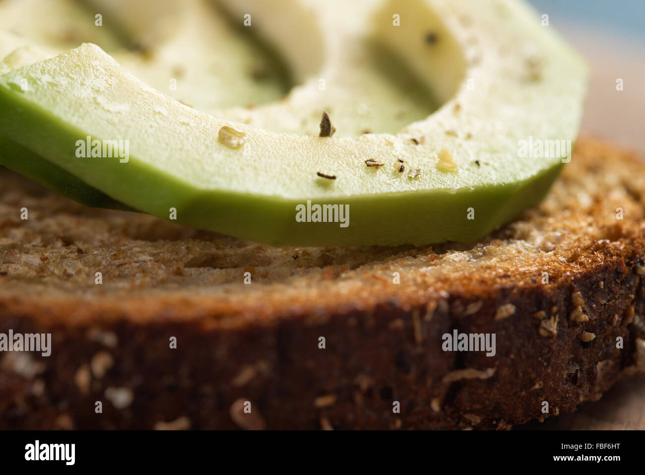 toasted rye bread with sliced avocado and herbs Stock Photo - Alamy