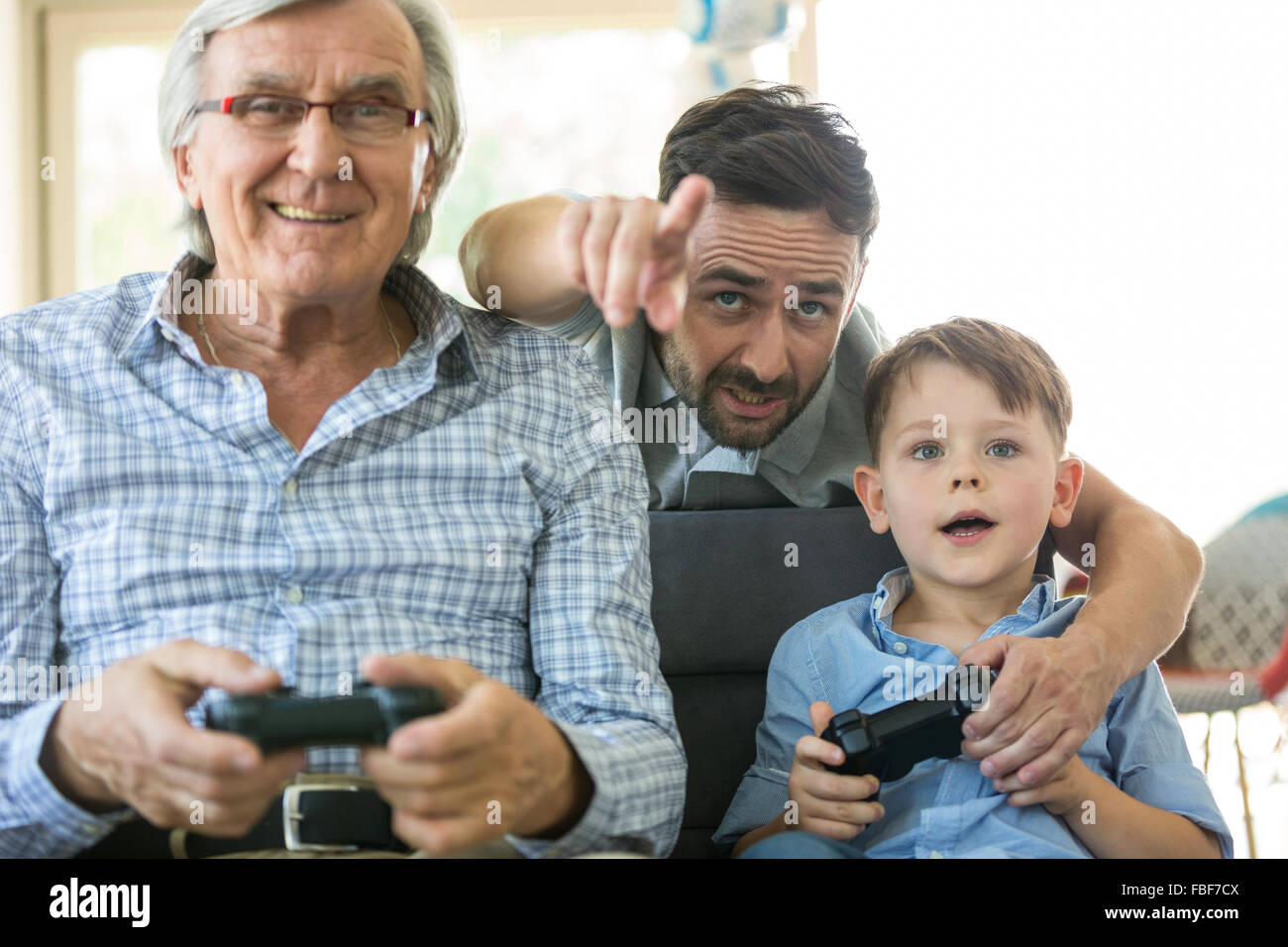 Family playing video games Stock Photo - Alamy