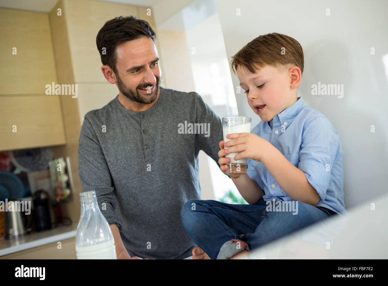 Father giving son a glass of milk Stock Photo - Alamy