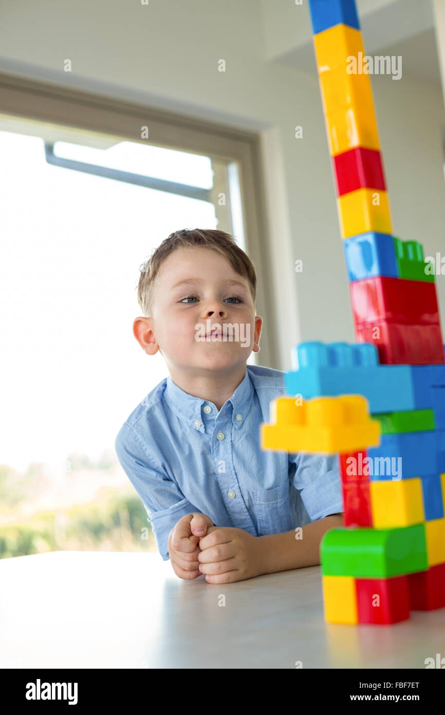 Cute boy playing with building blocks Stock Photo - Alamy