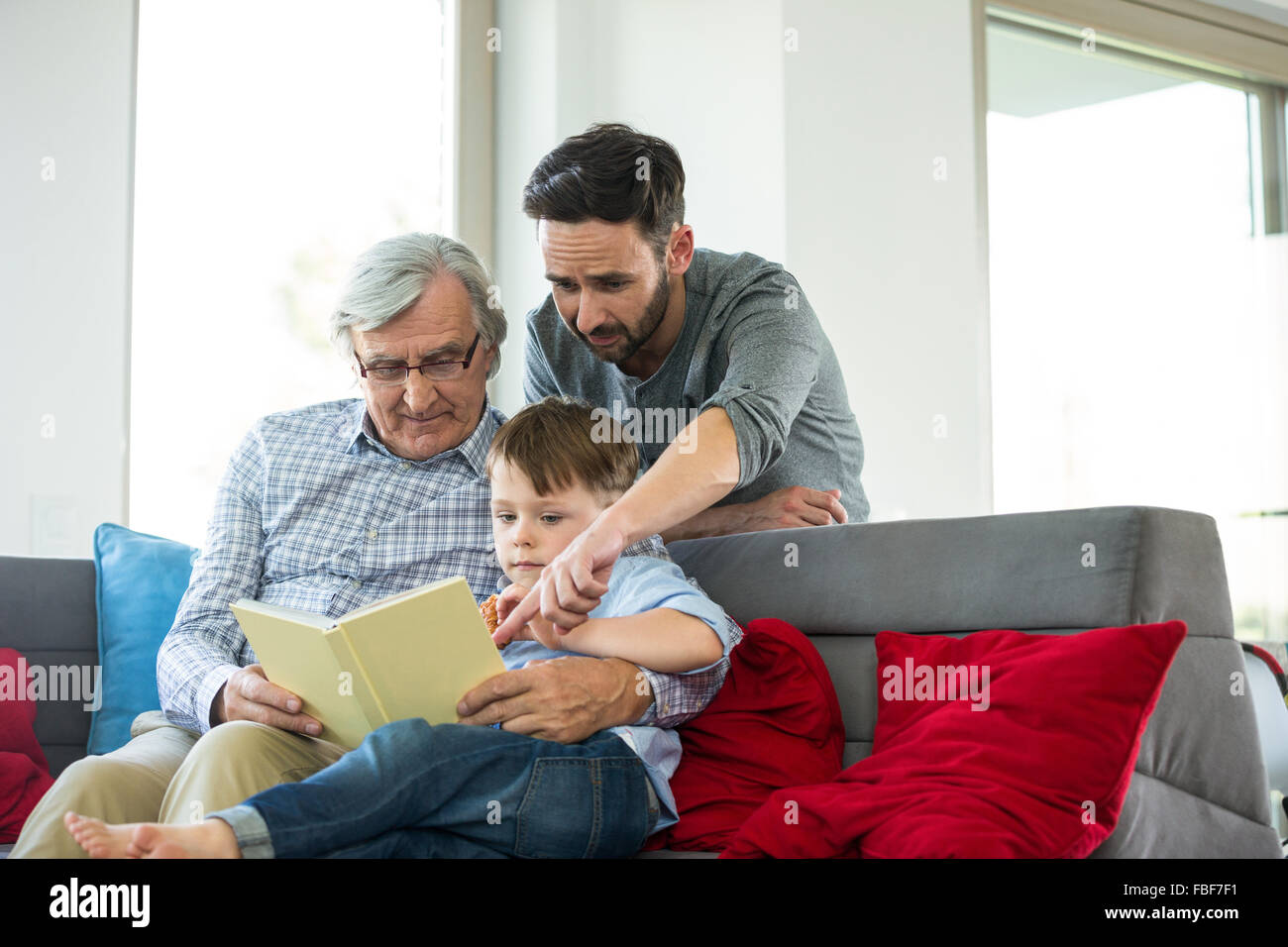 Smiling multi generation family reading hi-res stock photography and ...