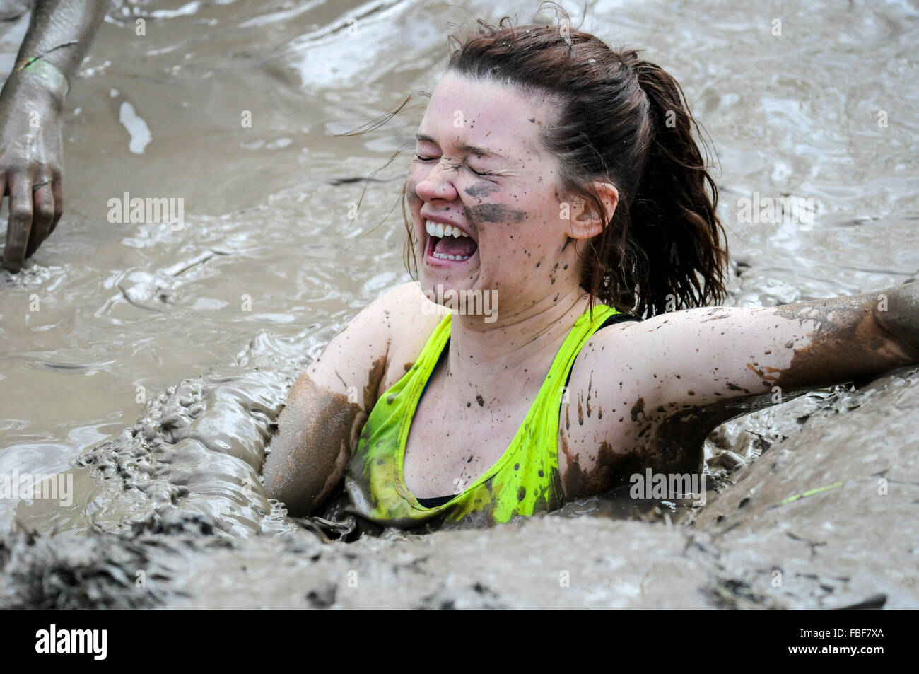 Mud covered single female runners at obstacle course race, UK Stock ...