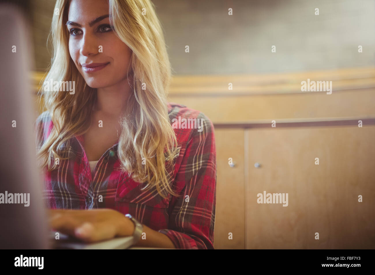 Smiling female student using laptop Stock Photo - Alamy