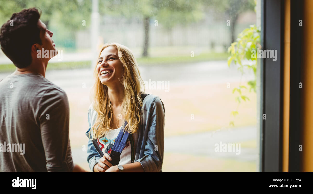 Smiling female student talking to a friend Stock Photo - Alamy