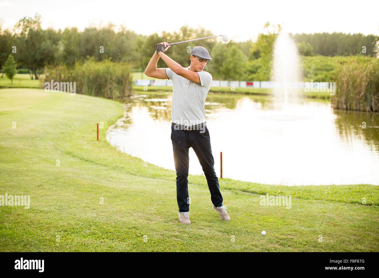 Young man playing golf Stock Photo - Alamy