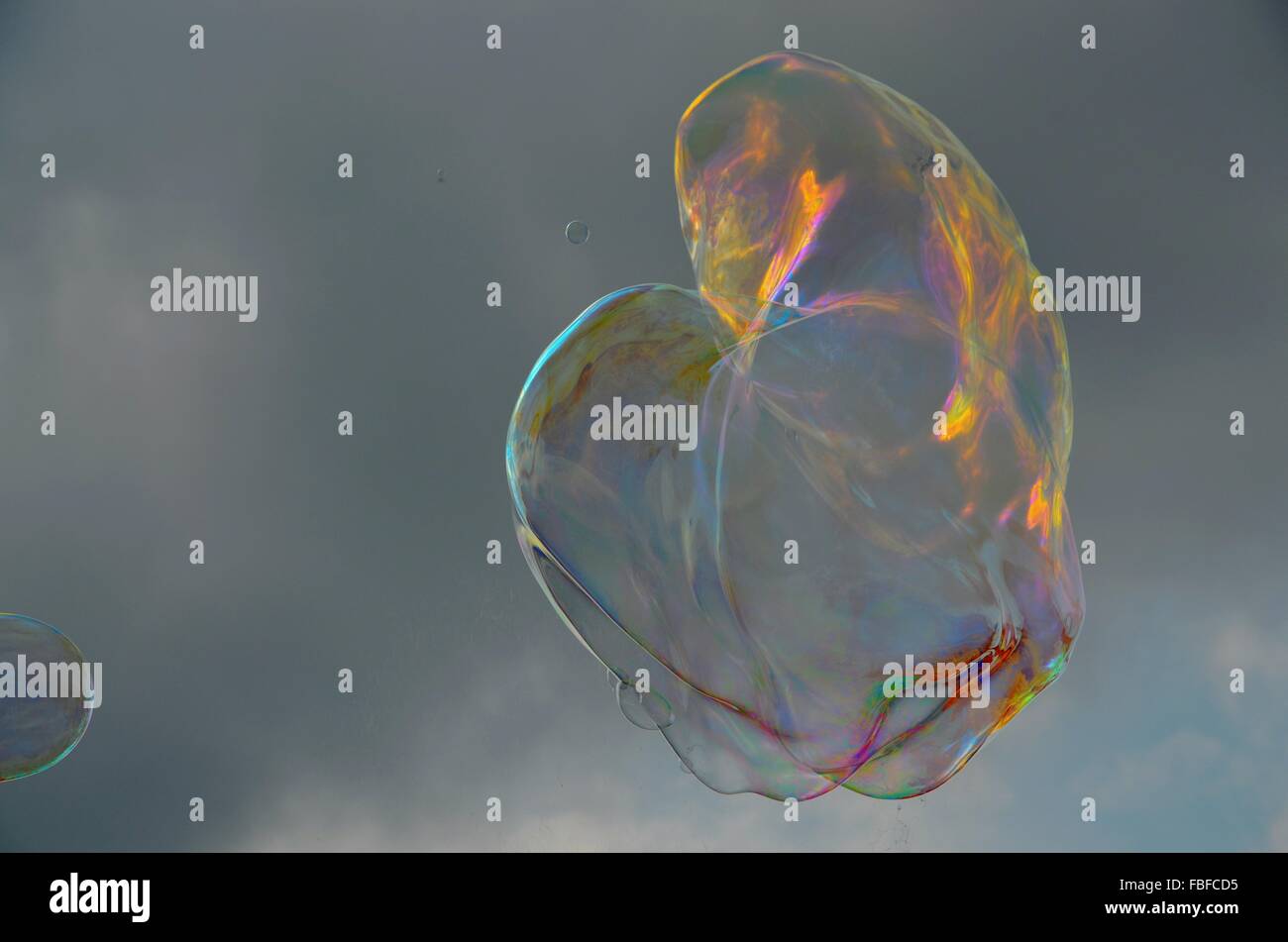 Low Angle View Of Bubbles In Mid-Air Against Cloudy Sky Stock Photo - Alamy