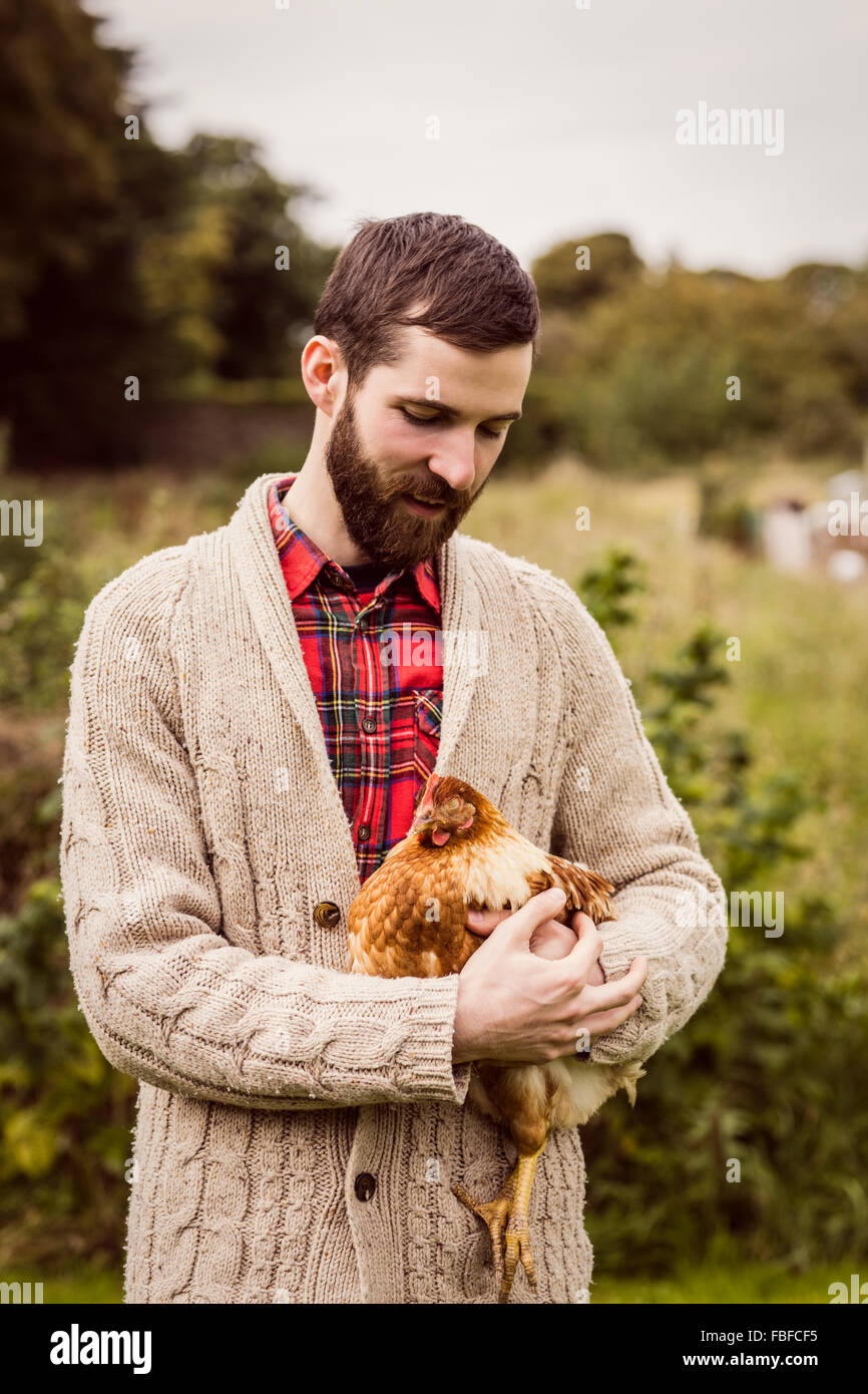 Smiling man holding chicken Stock Photo - Alamy