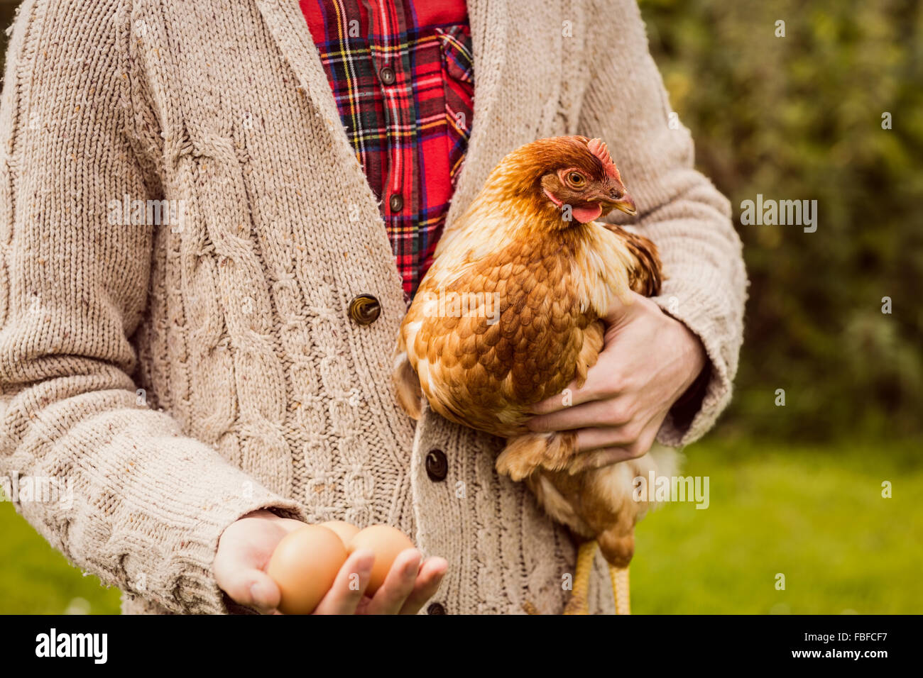Man holding chicken and egg Stock Photo - Alamy