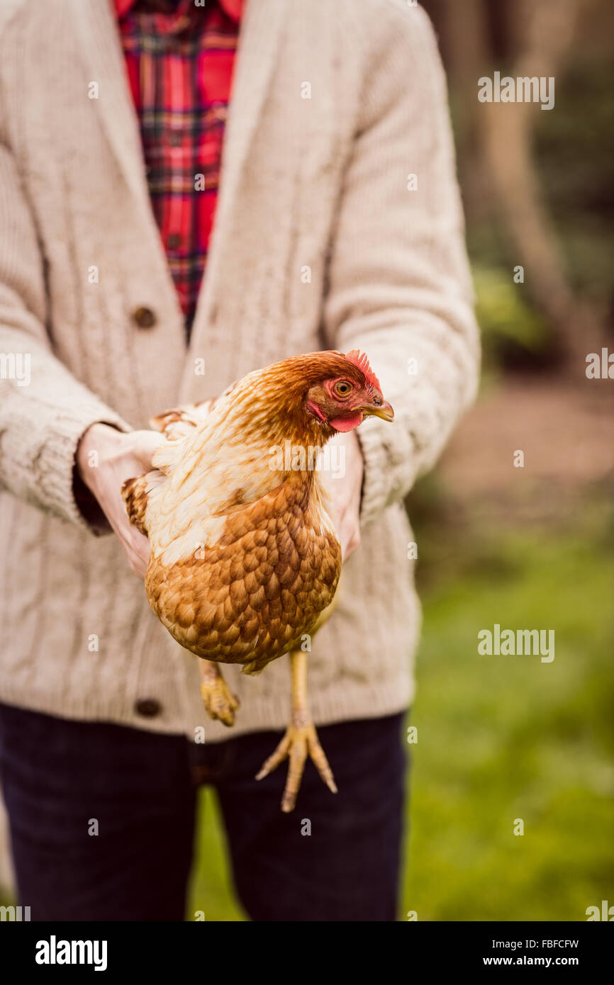 Man holding and showing chicken Stock Photo - Alamy