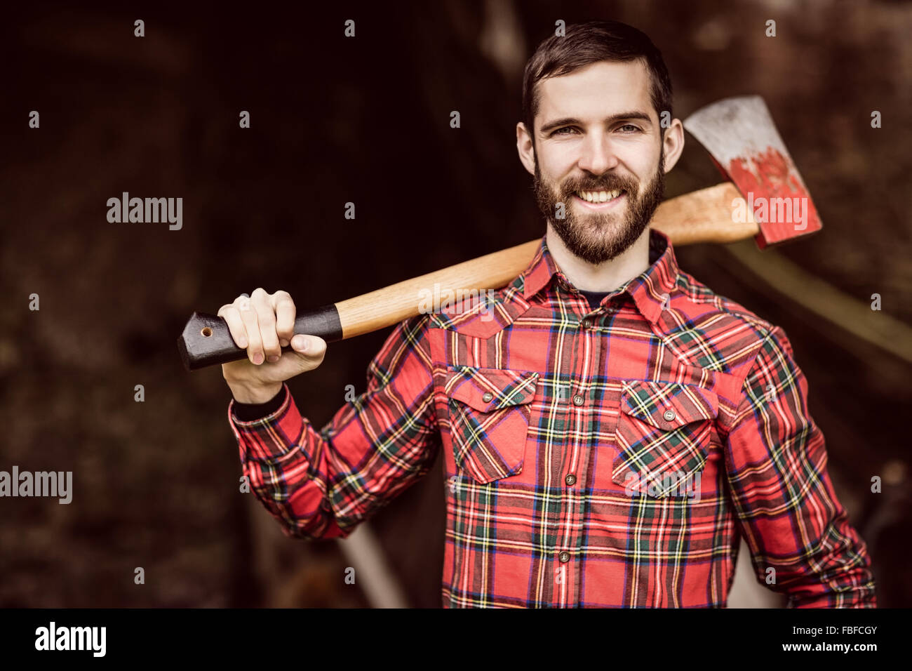Smiling man with axe Stock Photo - Alamy