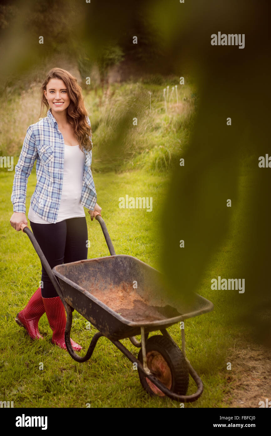 Woman with wheelbarrow hi-res stock photography and images - Alamy