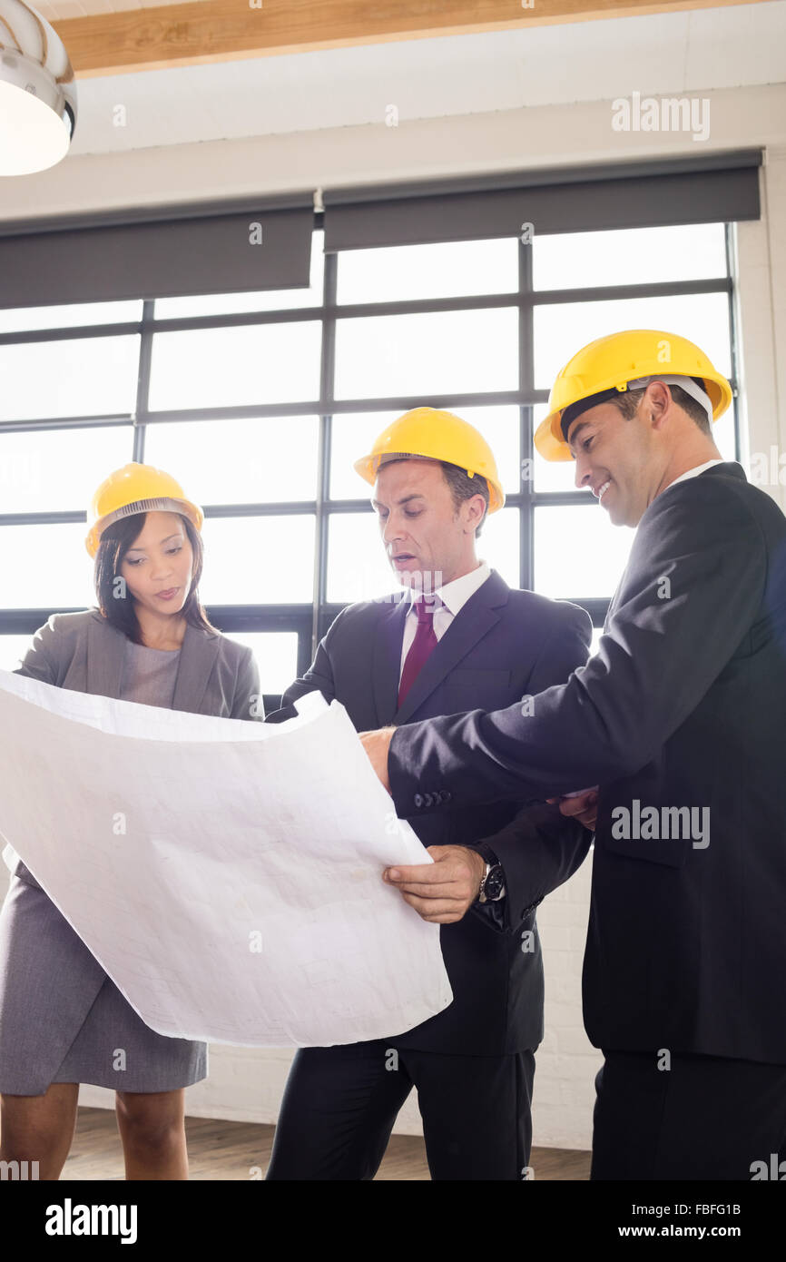 Business people wearing safety helmets Stock Photo - Alamy