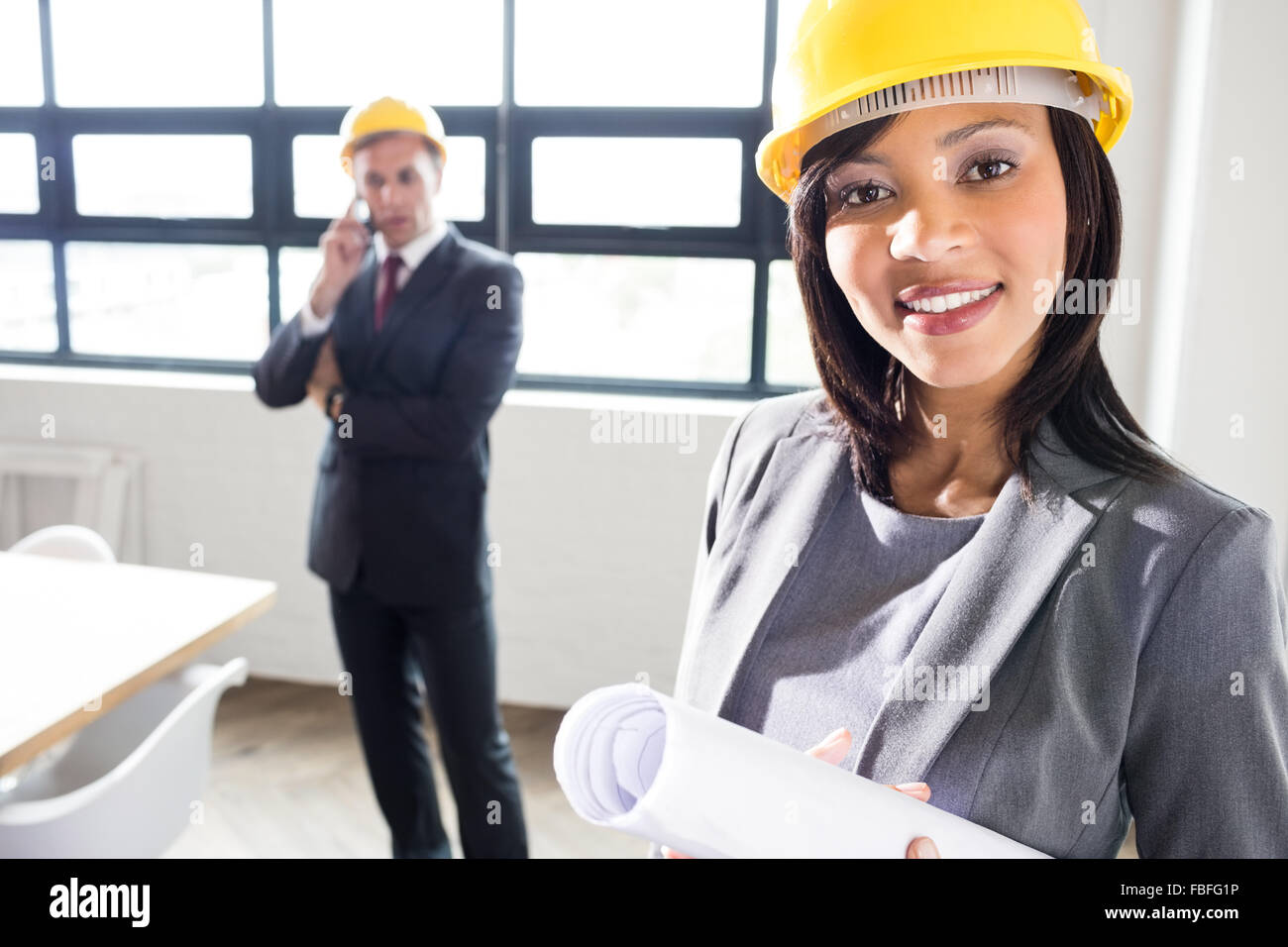 Business people wearing safety helmets Stock Photo - Alamy