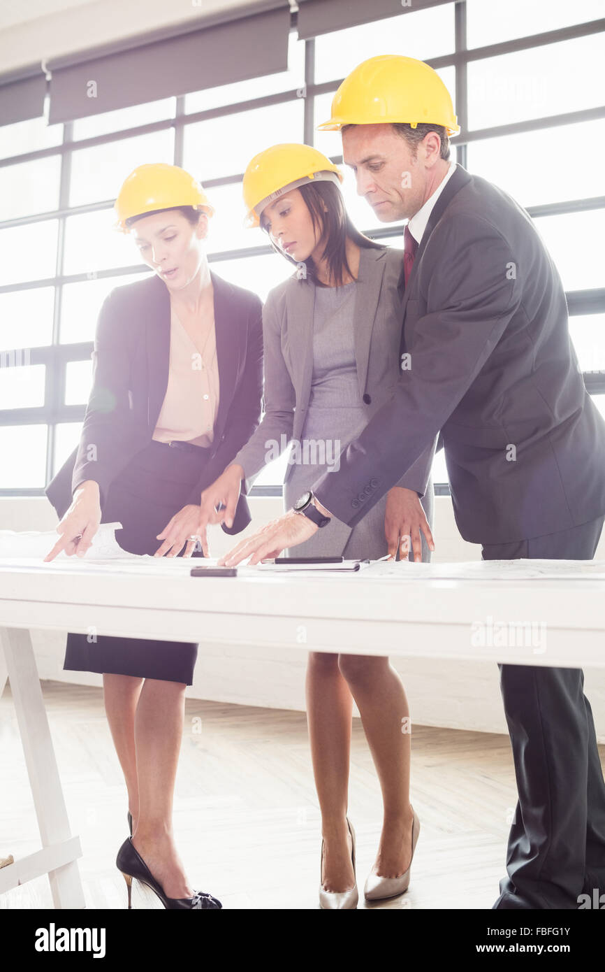 Business people wearing safety helmets Stock Photo - Alamy
