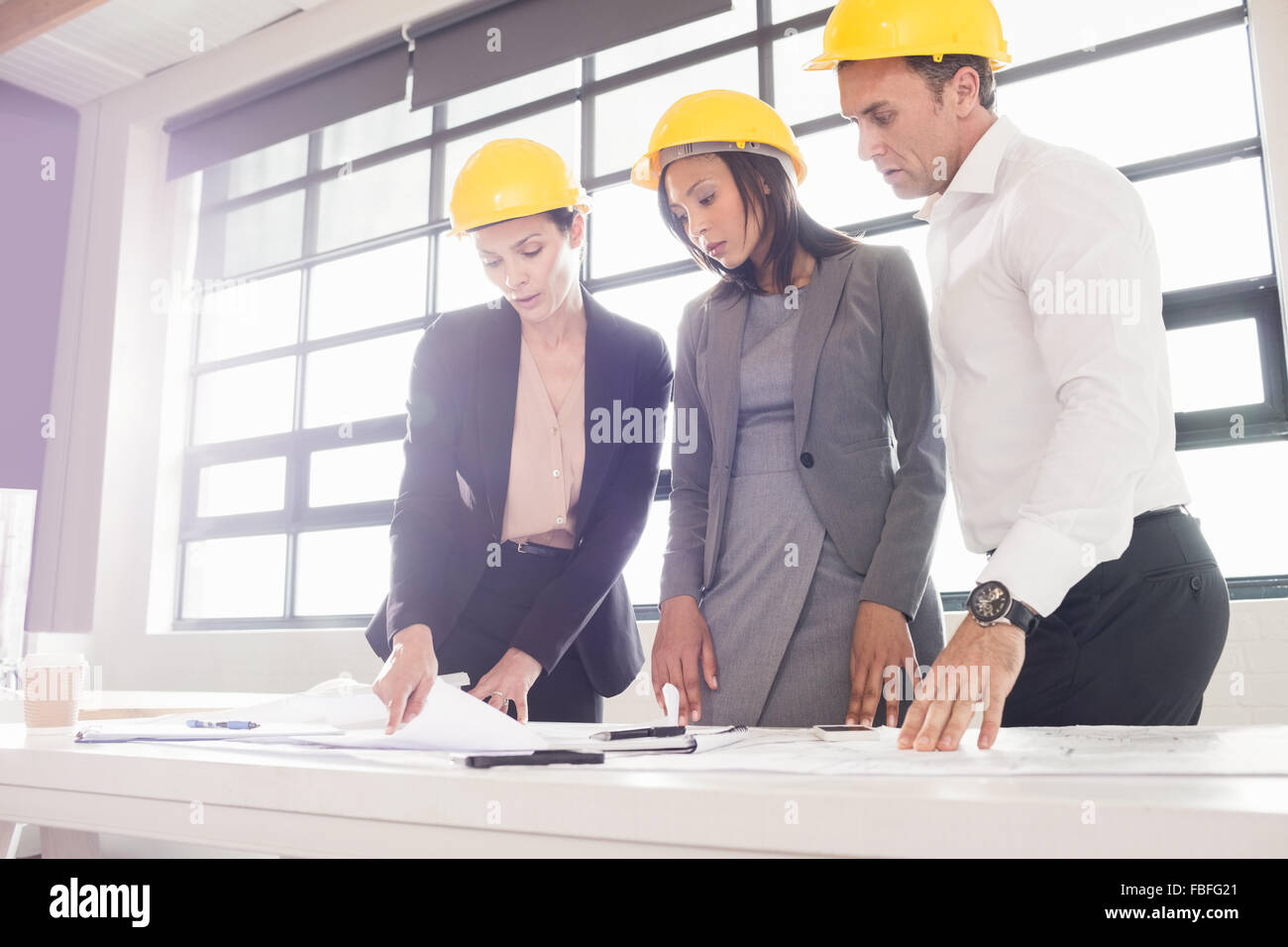 Business people wearing safety helmets Stock Photo - Alamy