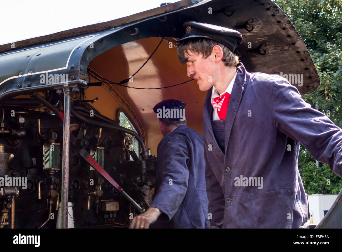 Firemen on U class locomotive at East Grinstead station Stock Photo - Alamy