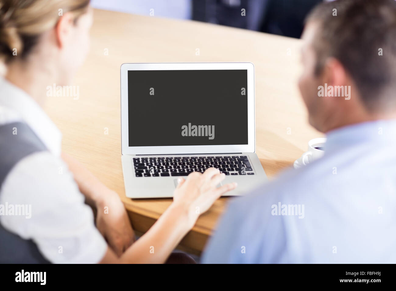 Business people working together while using laptop Stock Photo - Alamy