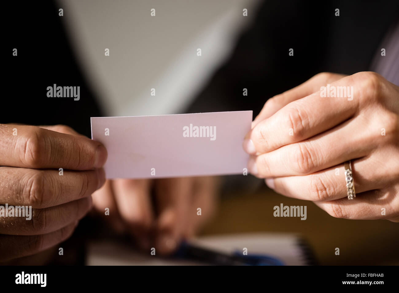 Business people holding card together Stock Photo - Alamy