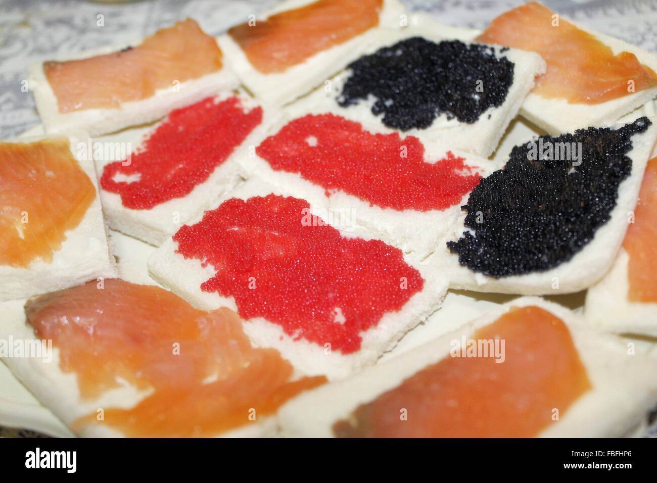 canape with red and black fish caviar and salmon Stock Photo - Alamy