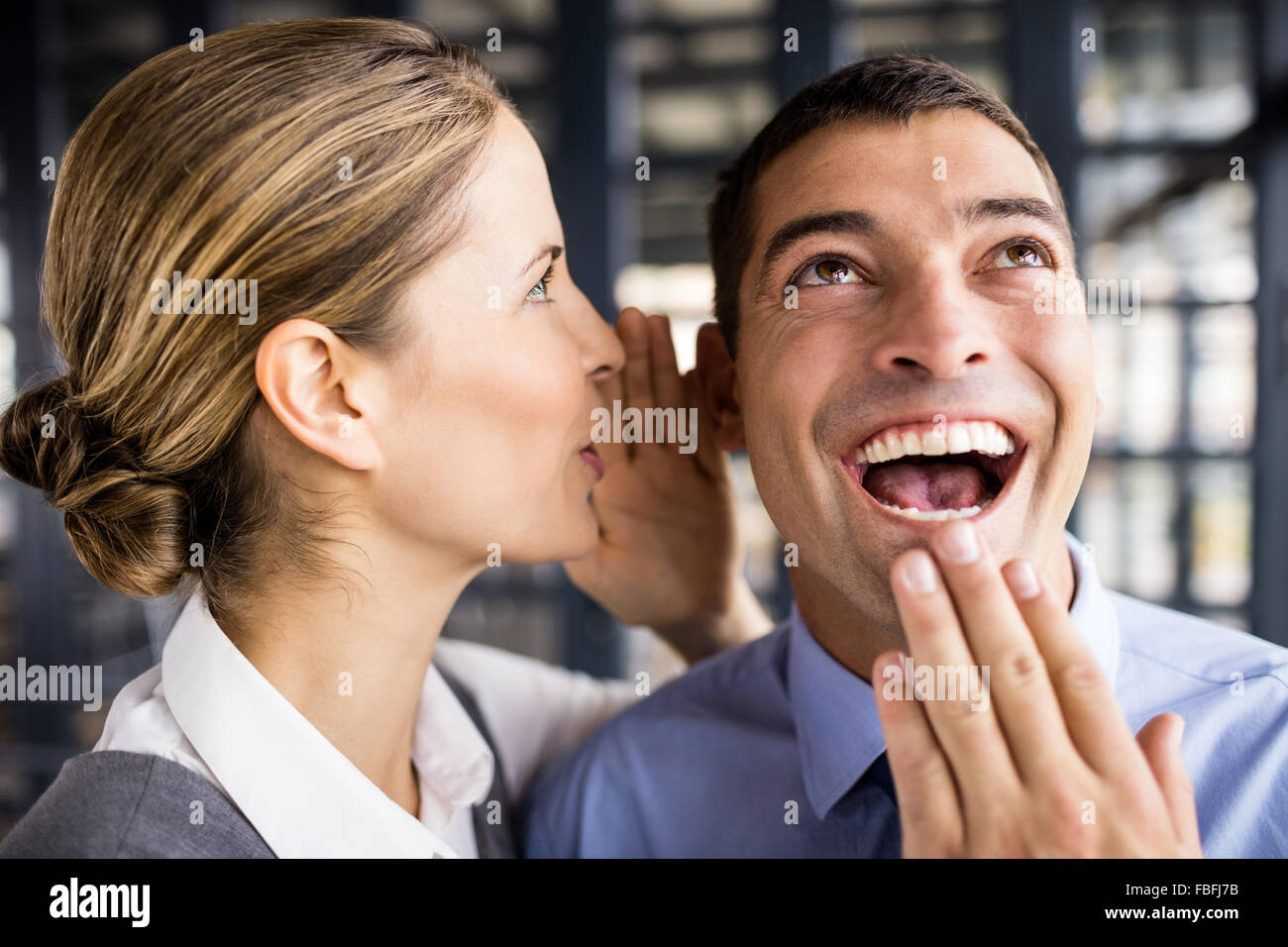 Young man woman whispering something hi-res stock photography and ...