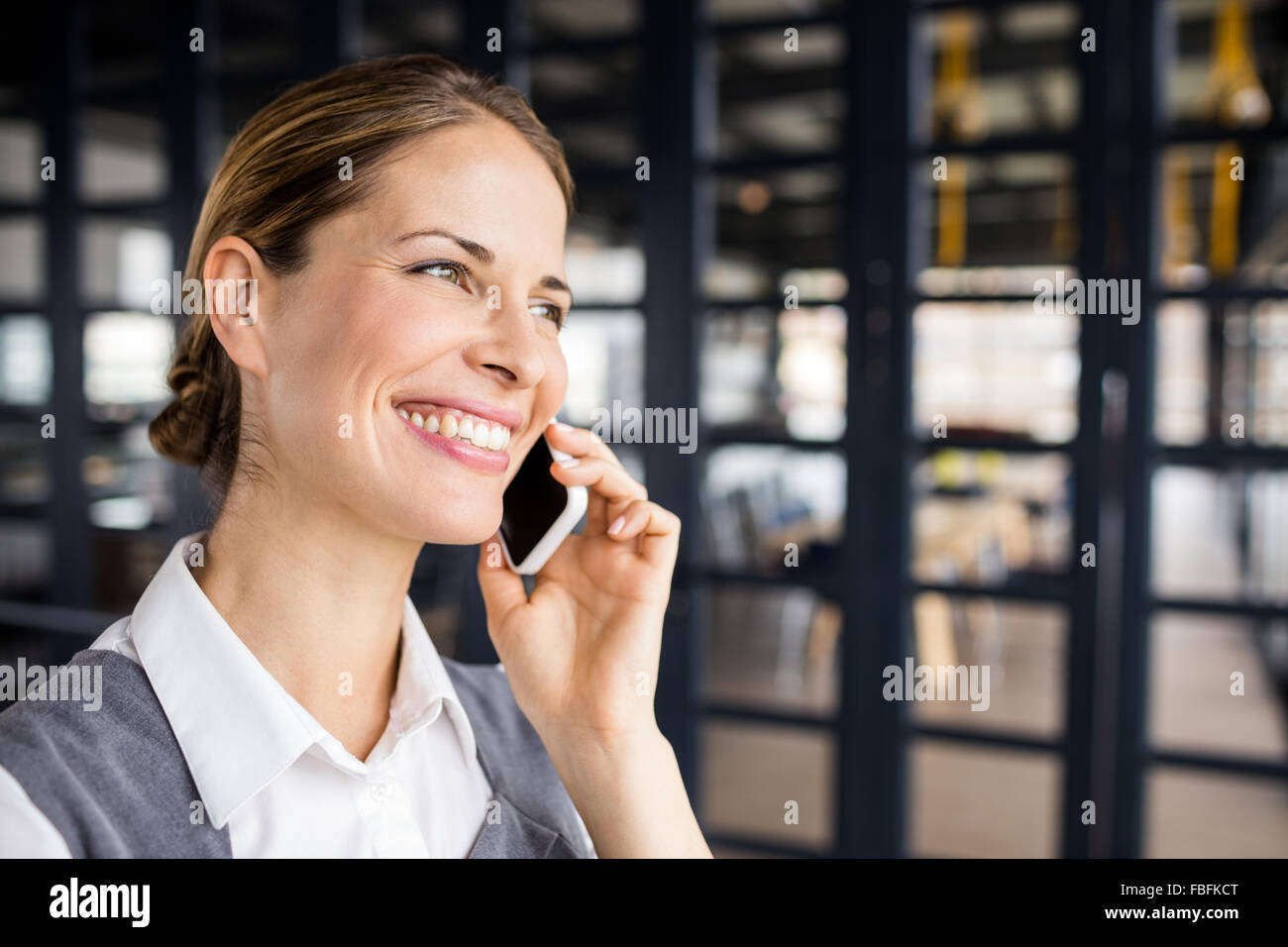 Portrait of a smiling businesswoman having a phone call Stock Photo - Alamy