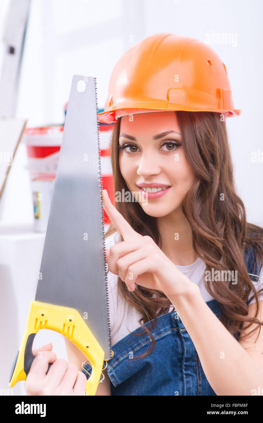 Young girl playing with a saw Stock Photo - Alamy