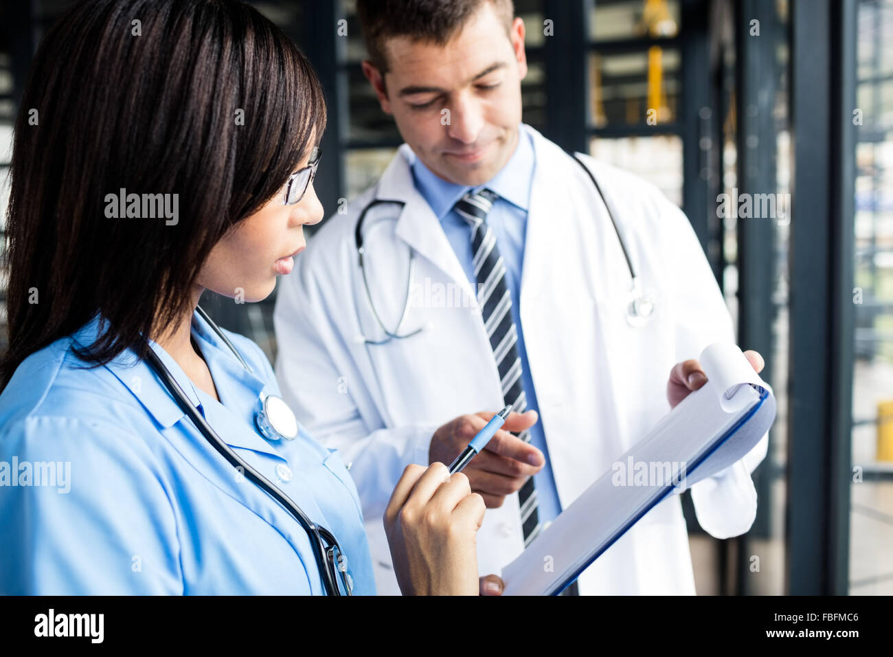 Doctor nurse looking documents hi-res stock photography and images - Alamy