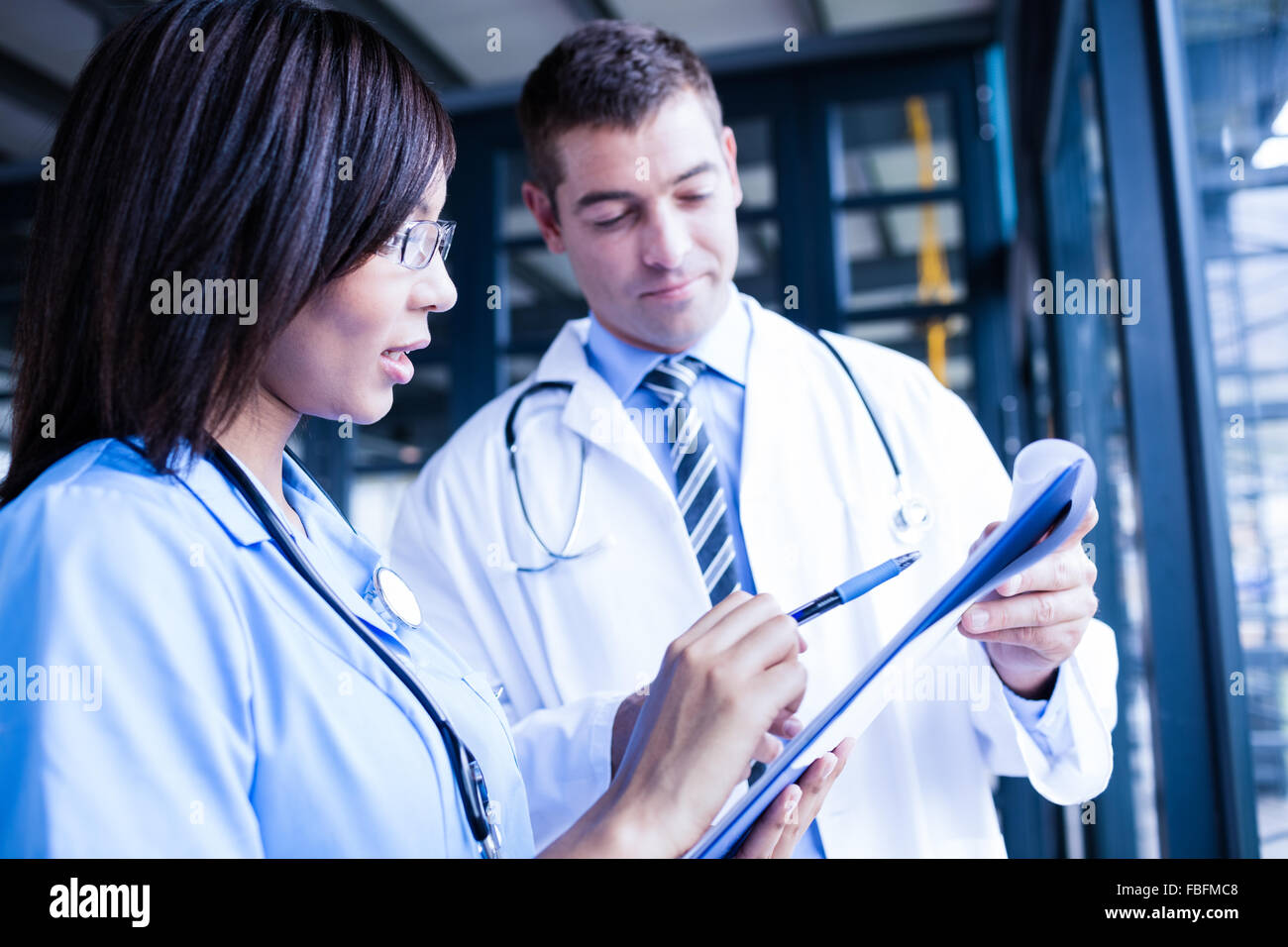 Nurse and doctor looking at files Stock Photo - Alamy