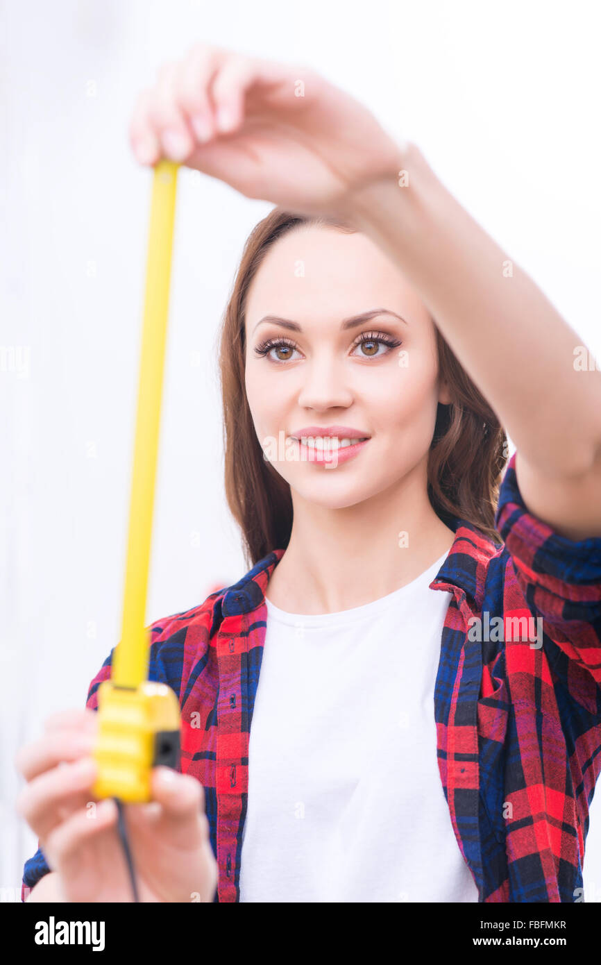 Pleasant young girl is using measure tape Stock Photo - Alamy