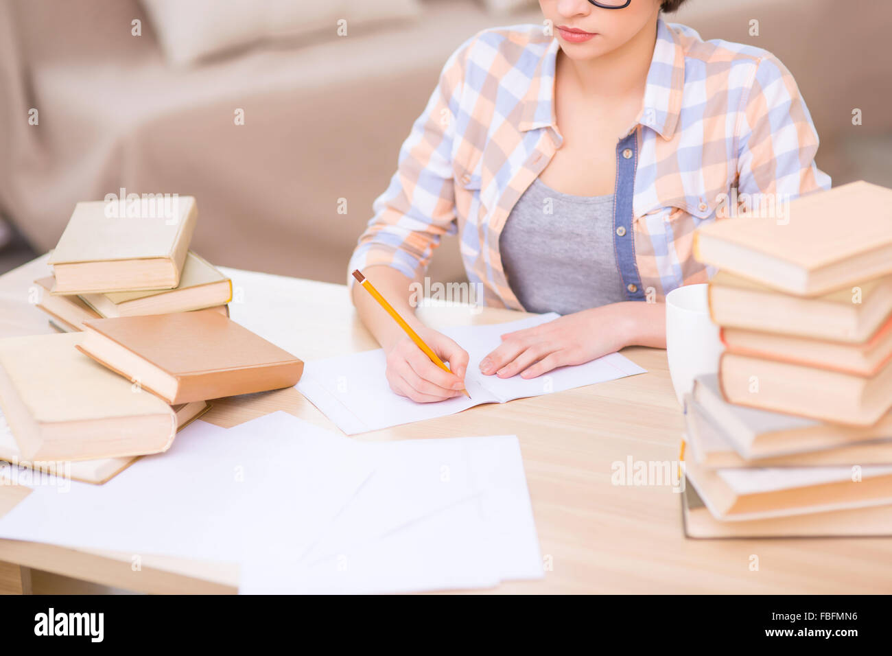 Young student girl is writing in her notebook Stock Photo - Alamy